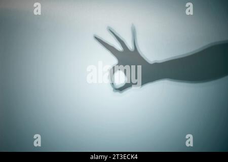 Shadow of a zombie's hand on a colored background. Scary Halloween ...