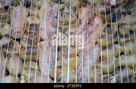 Grill potatoes and meat on wire rack closeup Stock Photo - Alamy