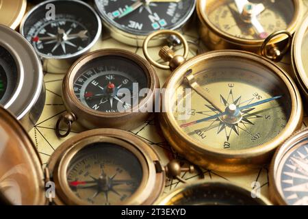 Many different compasses on an old map Stock Photo - Alamy