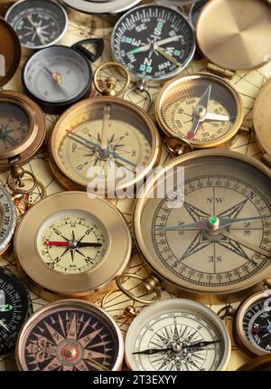 Many different compasses on an old map Stock Photo - Alamy