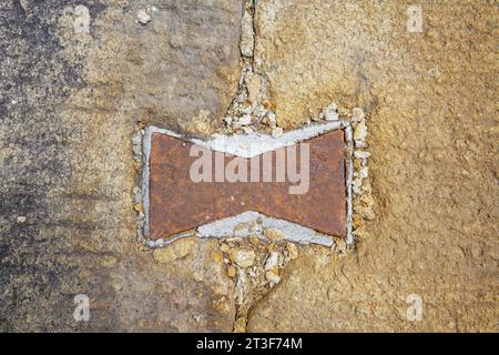 Metal components embedded in the middle of rocks Stock Photo - Alamy