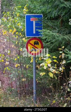 Road signs at small narrow forest road Stock Photo - Alamy