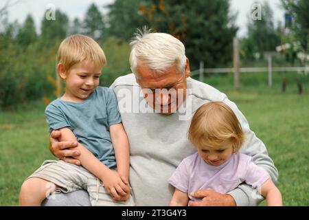 Grandfather and grandchildren have fun during walk In Park. Happy ...