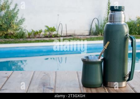 Thermos and mate, next to the pool on a table Stock Photo - Alamy