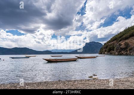 Pig trough boats on the surface of Lugu Lake in China Stock Photo - Alamy