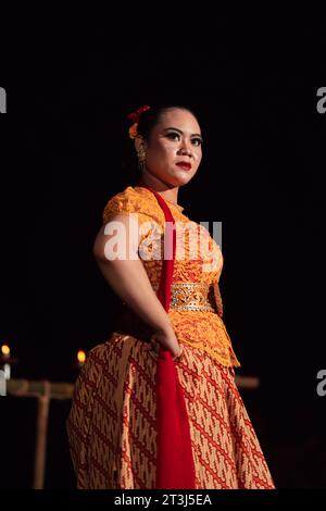 Brave Balinese woman poses with an angry expression while wearing a ...