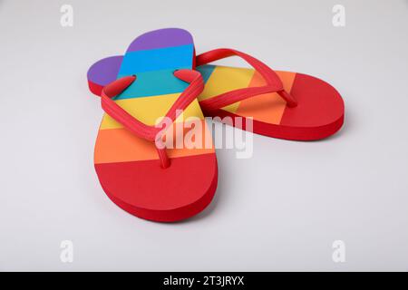 Stylish rainbow flip flops on white background, top view Stock Photo ...