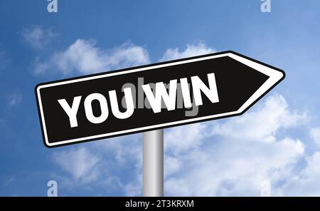 You win road sign on blue sky background Stock Photo - Alamy