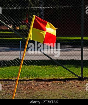 Red corner flag standing on a green soccer field with white lines Stock ...