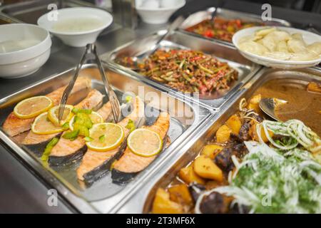 Salmon fillet. Various hot dishes . Glass Showcase in a buffet or self ...