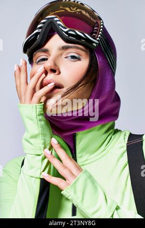 Young woman in balaclava posing with gun on red background Stock Photo ...
