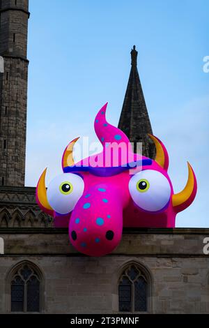 Magenta bug eyed Illuminated monster on Exchequer Gate building ...