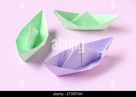 Colorful origami boats on purple background Stock Photo - Alamy