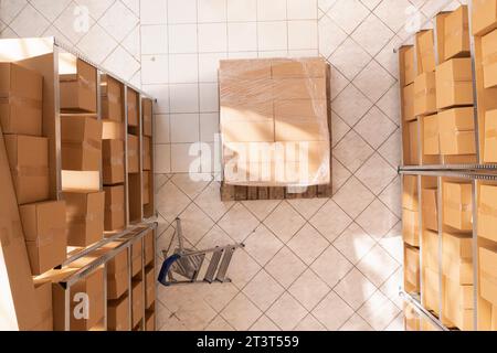 Interior of warehouse store with parcels and shelf unit Stock Photo - Alamy