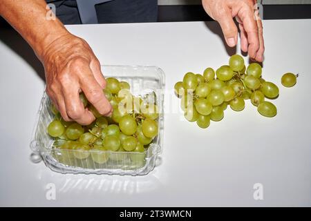 a woman holds grapes in her han Stock Photo - Alamy