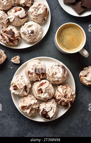 French blue meringue cookies and cup of coffee on white wooden ...