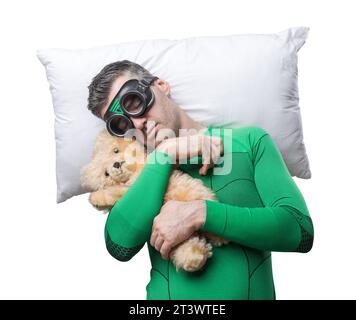 Superhero sleeping on a pillow floating in the air with hands clasped ...