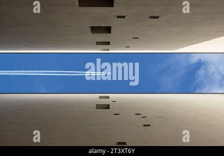 interior of a modern building with airplane trail and clear sky Stock ...