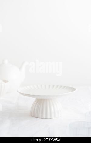 Empty tableware - white cakestand with a clear glass on white ...