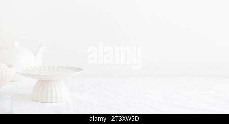 Empty tableware - white cakestand with a clear glass on white ...