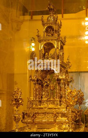 Murcia Cathedral, Spain. Gold-colored metallic urn behind a glass. The ...