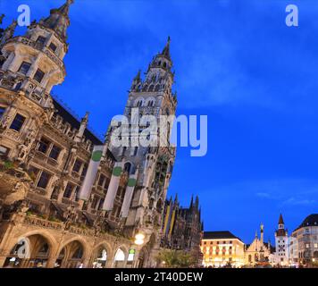 Mary's square illuminated at dusk in Munich, Germany with old town hall ...