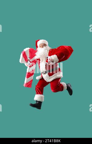 Jumping Santa Claus with candy cane pinata on green background Stock ...