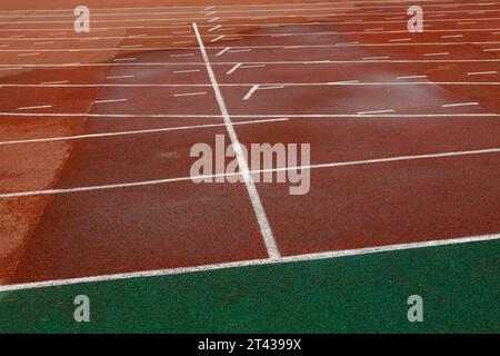 wet red plastic runway in a sports ground in a middle school Stock ...