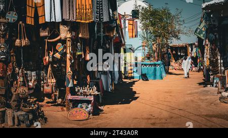 A Nubian market street lined with various stalls selling textiles ...