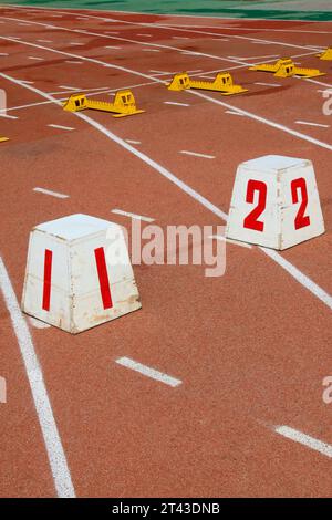 Serial number marked and run up ware on red plastic runway in a sports ...