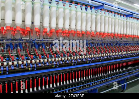 Textile spindles on the production line, closeup of photo Stock Photo ...