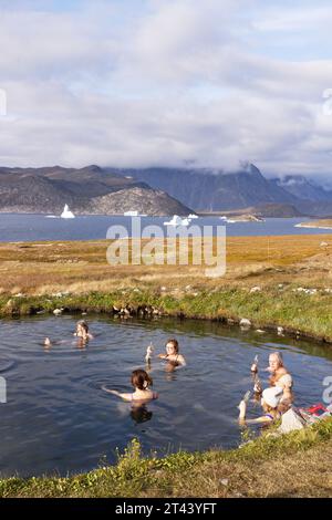 Greenland tourists; people swimming in hot springs at Uunartoq island ...