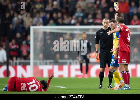 Referee Andrew Kitchen shows a yellow card to Dominic Hyam #5 of ...