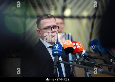 Finland's Prime Minister Petteri Orpo, center, speaks with the media as he arrives for an EU ...