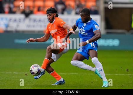 David Ajiboye #16 of Peterborough United competes with Dominic Thompson ...