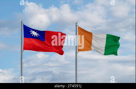 Taiwan and Ivory Coast flags waving together in the wind on blue cloudy ...