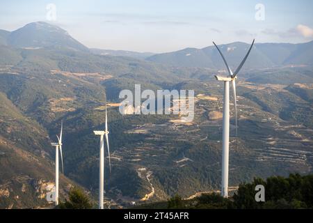 Wind turbines in Hatay Turkey behind the ruins of historic Monastery of ...