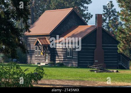 Plain WA USA Sept 14 2023: Old Log Barn in background is haze from a ...