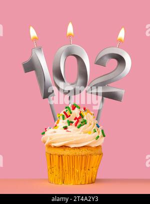 Birthday card with candle number 102 - purple background Stock Photo ...