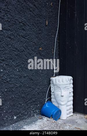 Bizarre still life with a sphinx from the hardware store and a blue ...
