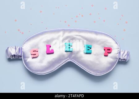 Composition with sleep mask, word SLEEP and sequins on color background ...