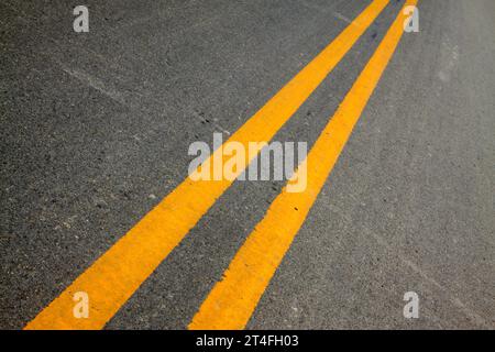 yellow double solid line on the road Stock Photo - Alamy