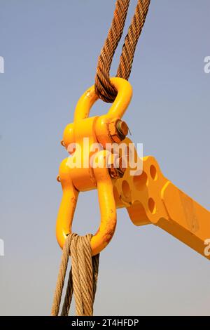 yellow metal fasteners and wire rope, closeup of photo Stock Photo - Alamy