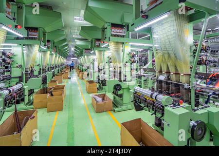 Elastic weaving workshop at textile factory in industrial zone in Ho ...