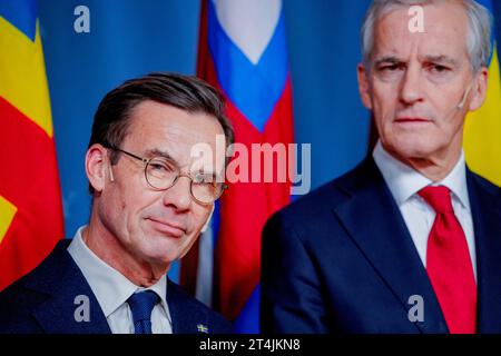 Sweden's Prime Minister Ulf Kristersson, centre, Colonel Cedric Aspirault, Commander of the NATO ...