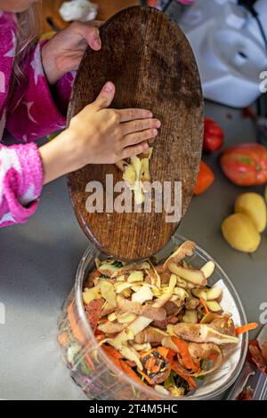 Throw carrot and potato skins into the trash. waste sorting Stock Photo ...