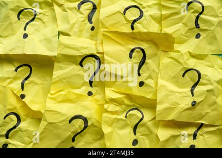 Questions and answers concept QnA. Yellow and crumpled memo note ...