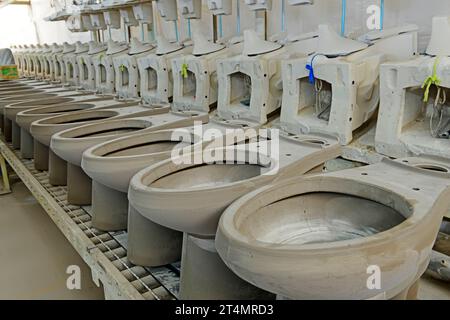 toilet unpainted clay idol in production workshop, closeup of photo ...