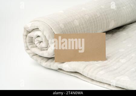 Warm cotton muslin blanket with paper tag on white background Stock ...