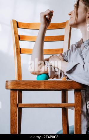 Woman doing triceps MFR with therapy ball and cork block Stock Photo ...